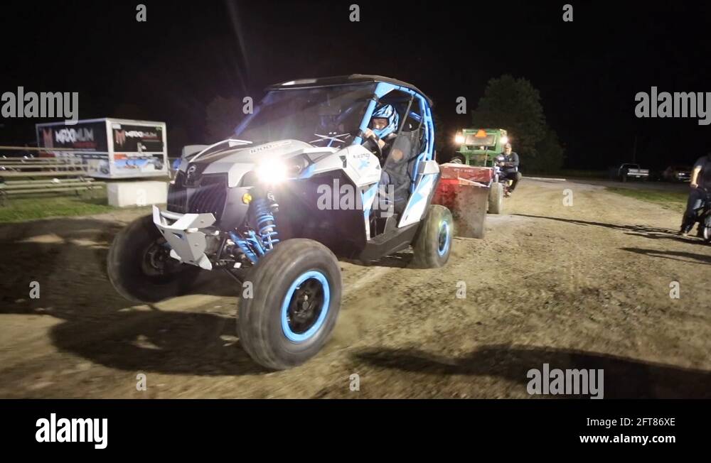 UTV side by side pulls heavy weight sled Stock Video Footage - Alamy