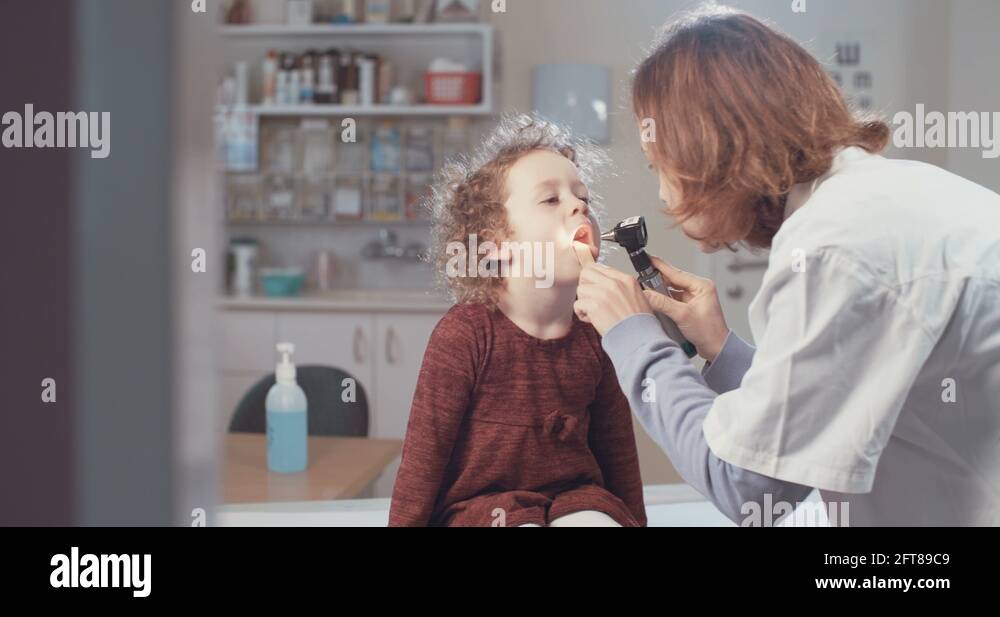 Female doctor checking a little girl in the infirmary Stock Video ...