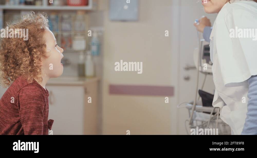 Female doctor checking a cute little girl in the infirmary Stock Video ...