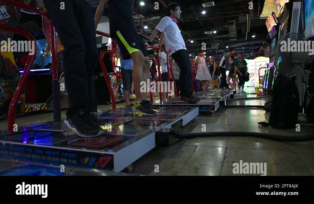 Boys playing popular dancing game Dance Dance Revolution Arcade Stock ...