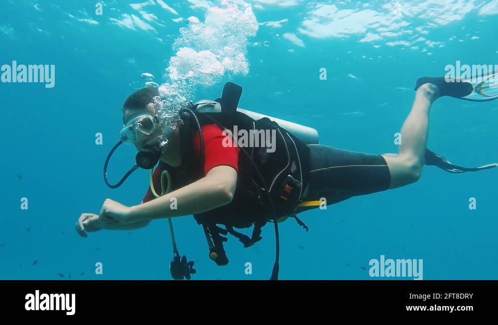 Novice diver learns to swim with scuba diving. Side view Stock Video ...