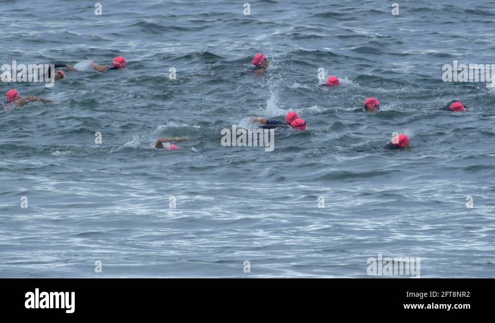 Athletes compete in the ocean swimming part of a triathlon Stock Video ...