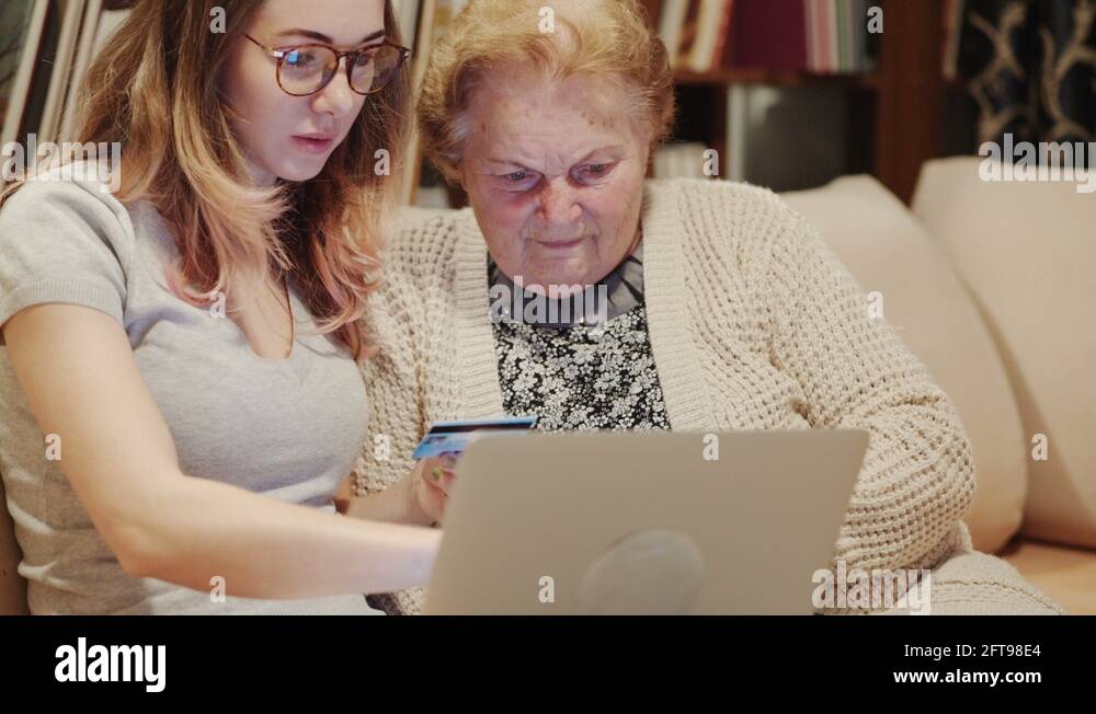 Young girl teaching and showing new computer technology to her ...