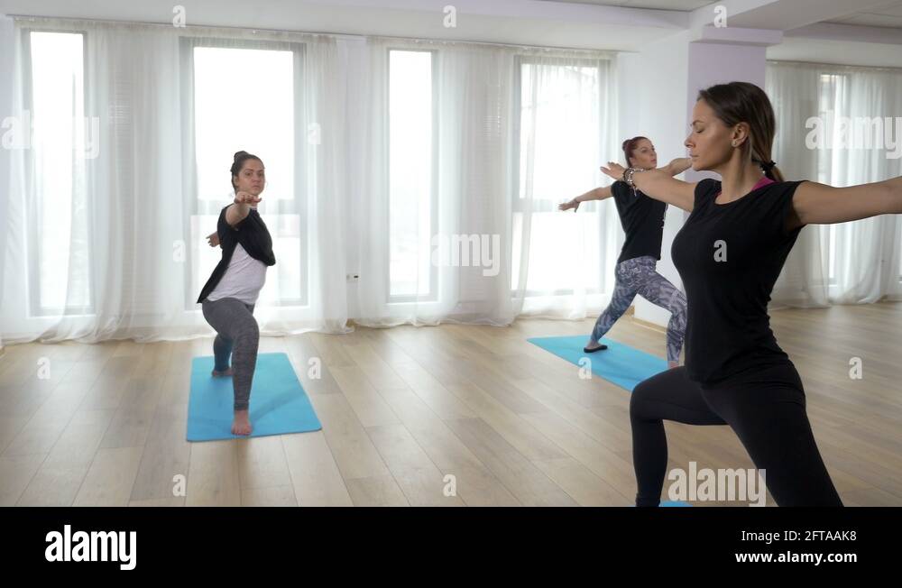 Yoga class warrior pose Stock Videos & Footage - HD and 4K Video Clips ...