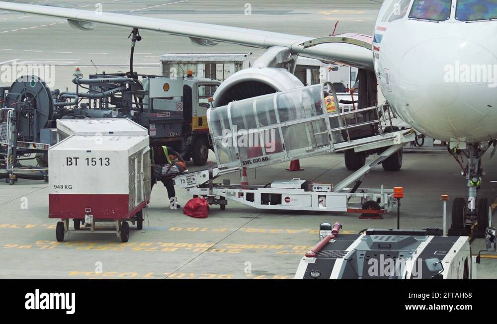 Ground Crew Using Conveyor Belt to Unload Baggage from Plane in Changi ...