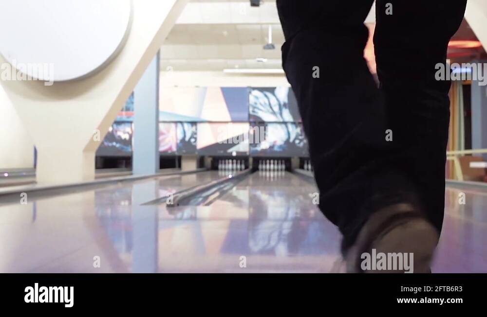 Man playing bowling throwing ball lane HD video. Girl rolling alley ...