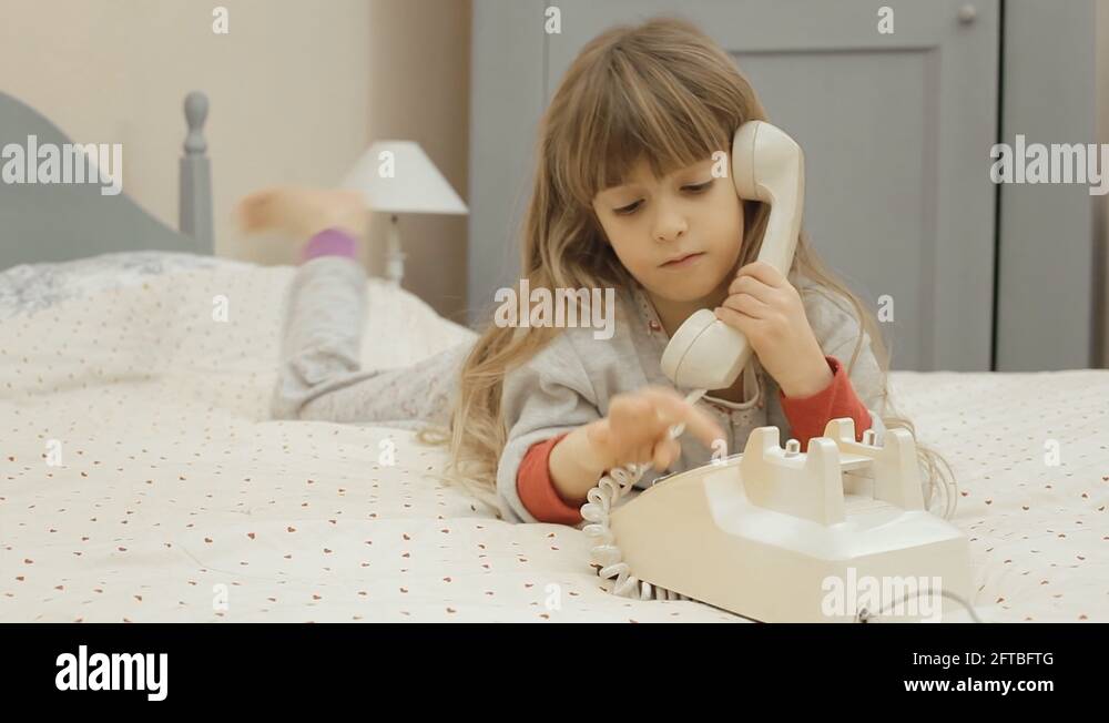 Little girl bed rotary phone call Stock Video Footage - Alamy