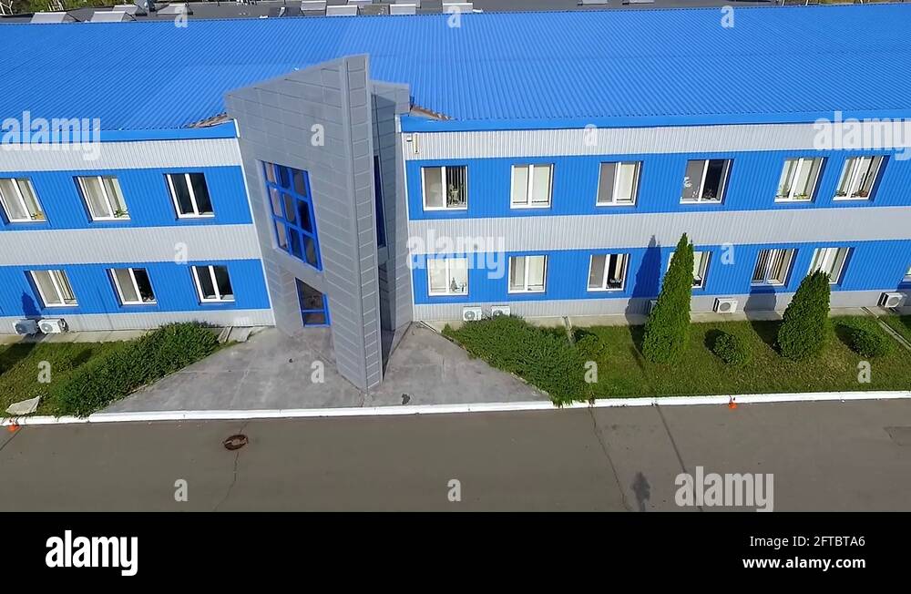 Flight beside warehouse storage building facade exterior HD aerial ...
