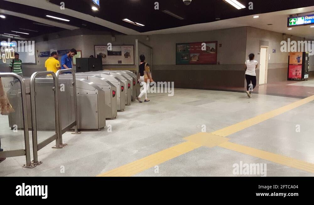 People cross underground subway metro train station barrier, New Delhi ...