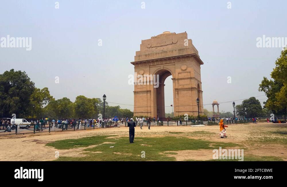Crowd of many tourist people, India Gate memorial monument, long shot ...