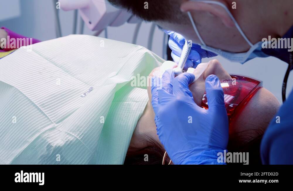 Dental drill handles the tooth surface , flushing after drilling ...