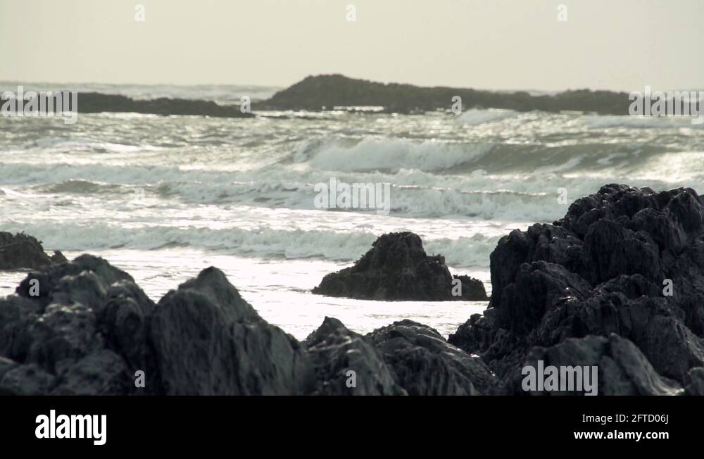 Sunlight On A Stormy Rocky Beach. Slow motion footage of large storm ...