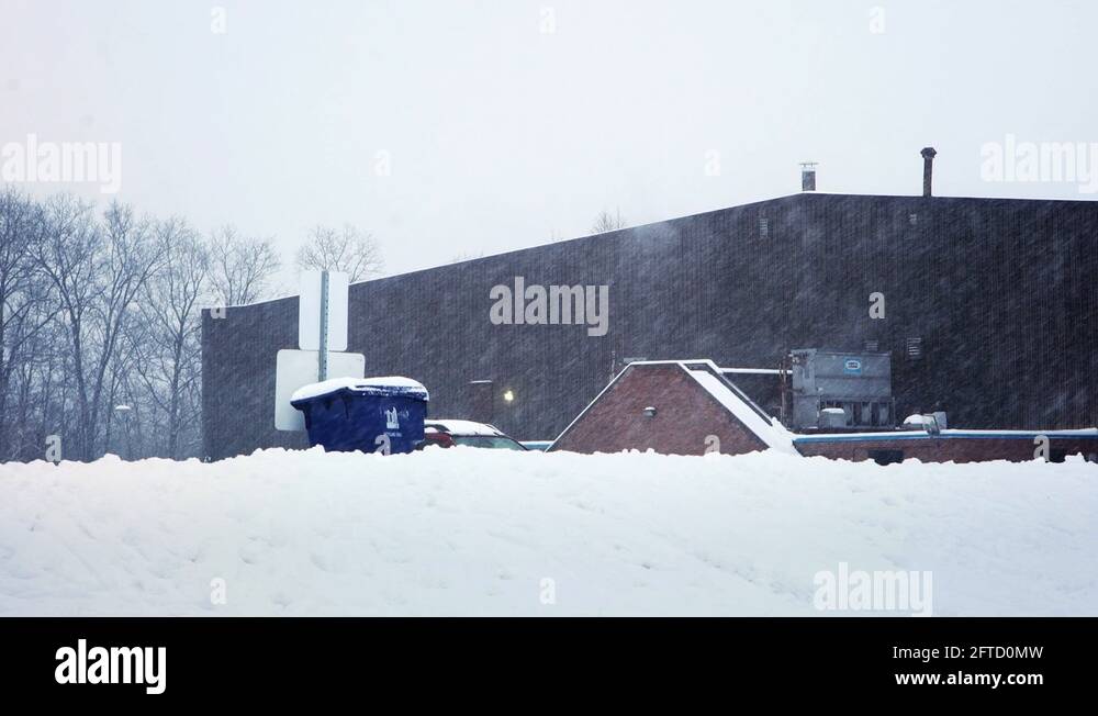 Snow bank and a large metal roof with HVAC and chimneys. Exterior hokey ...