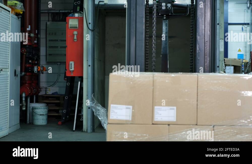 Forked Automatic Guided Vehicles (AGV) pallet truck goes into an ...