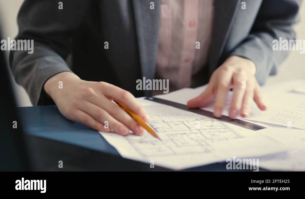 architect checking numbers on blueprint during house construction ...