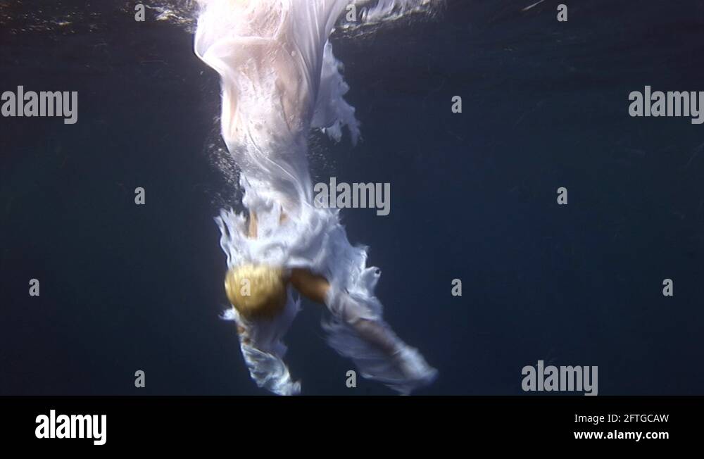 Underwater model in angel costume poses for camera in the Red Sea Stock ...