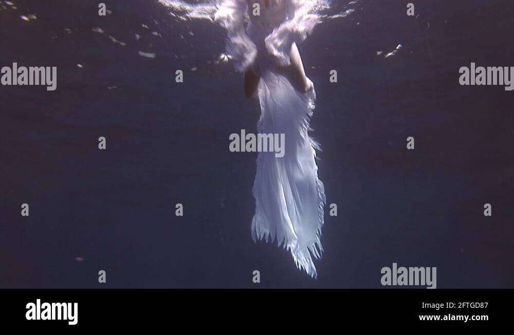 Underwater model in angel costume poses for camera in the Red Sea Stock ...