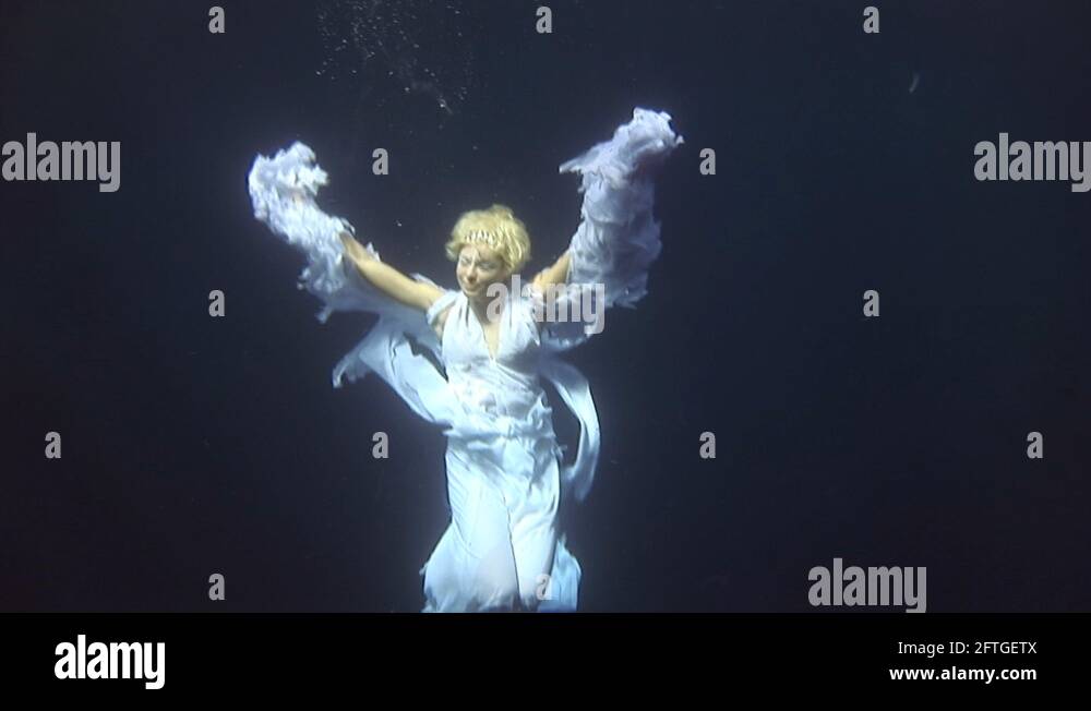 Underwater model in angel costume poses for camera in the Red Sea Stock ...