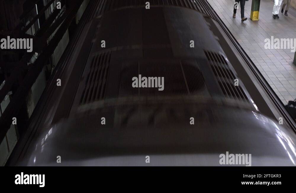 Train departing underground subway stop overhead view in New York City ...