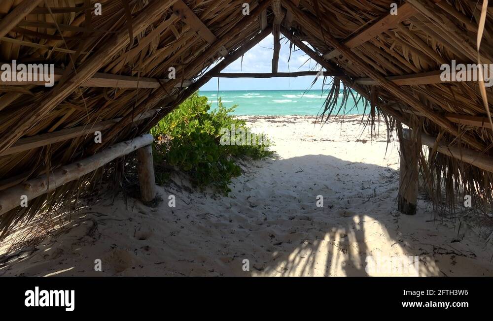 View of the sea through a shadow hut at the Playa Las Gaviotas. Cayo ...
