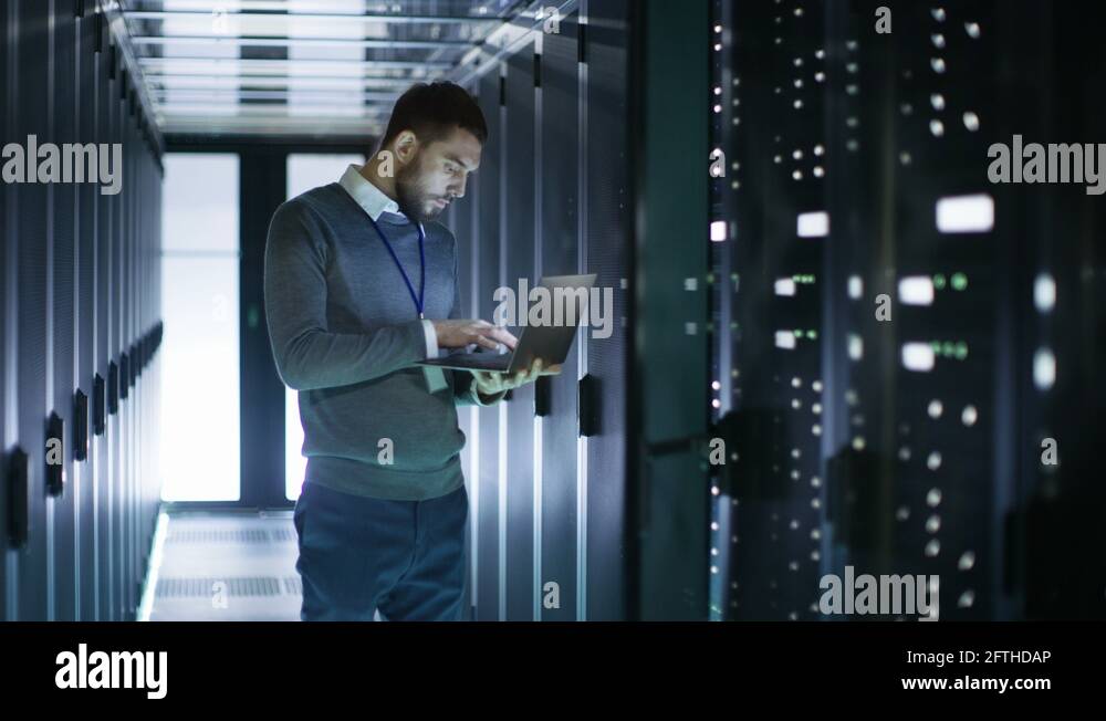 Male Server Engineer in Data Center. He Stands Before Open Door of Rack ...