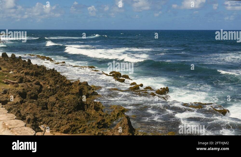 Waves roll onto rocky shore line on the Puerto Rico north shore Stock ...