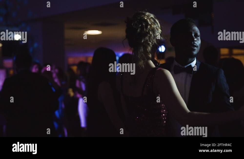 Romantic couple flirting and slow dancing close together on dance floor ...