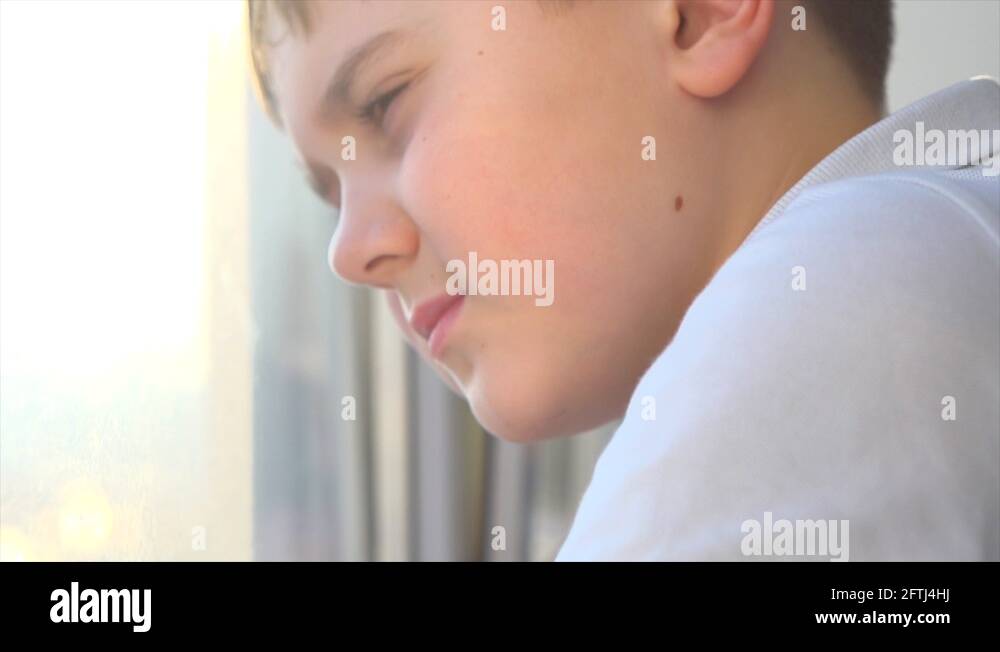 Kid looking out the window. Little boy looking though the window ...