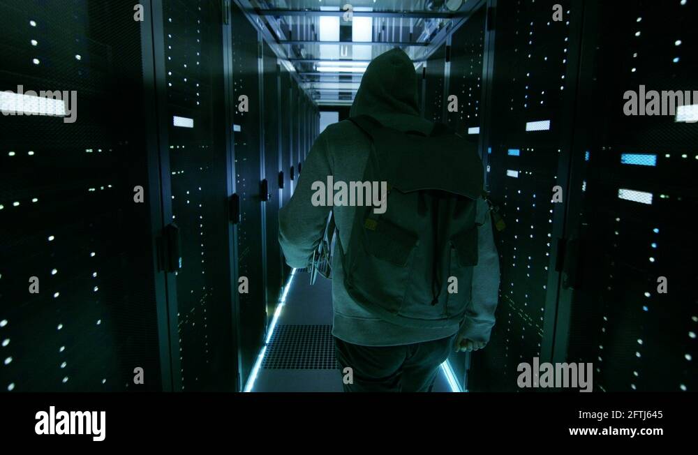 Back View of a Hacker Sneaking in Corporate Data Center Stock Video ...