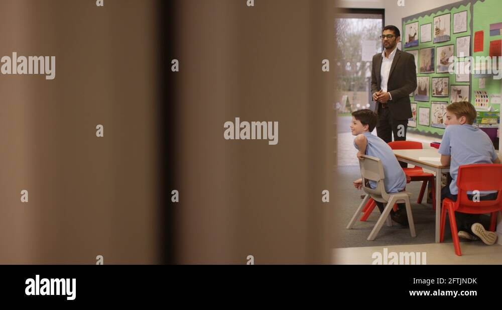 4k, Elementary children and their teacher in a lesson at school. Slow ...