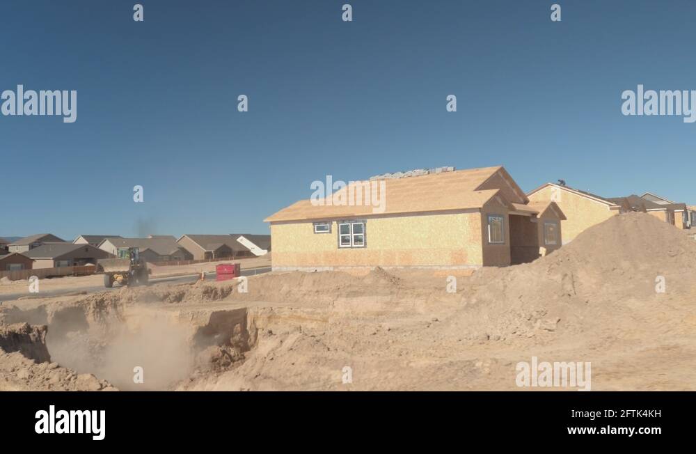 CLOSE UP: Borrow pit being dug, several family row houses under construction Stock Video Footage ...