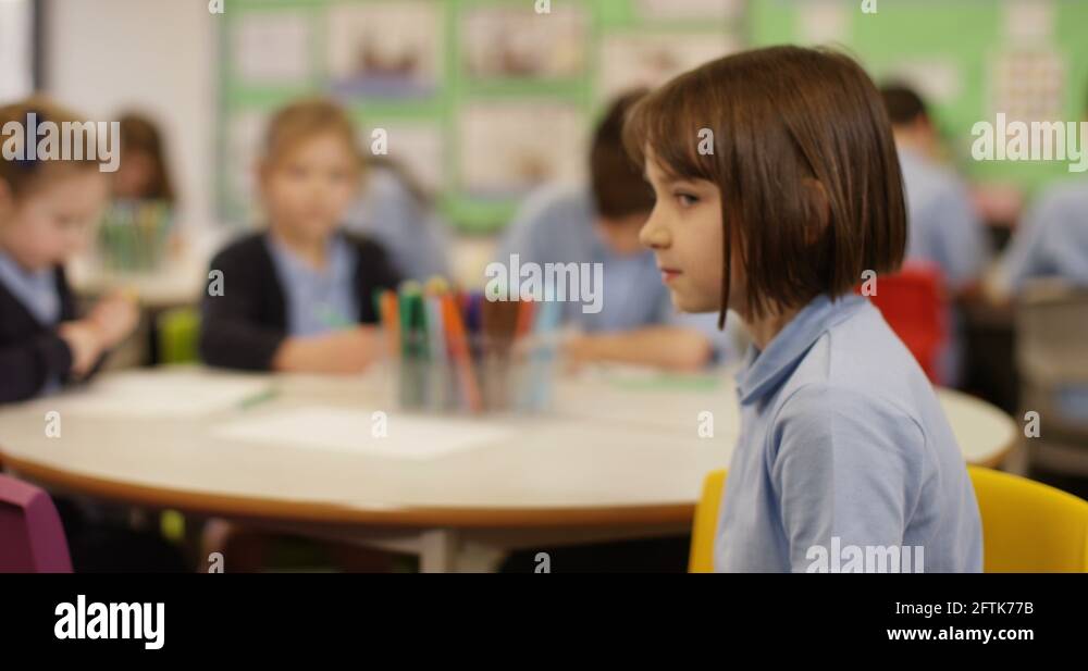 4K Portrait cute smiling little girl in primary school classroom Stock ...