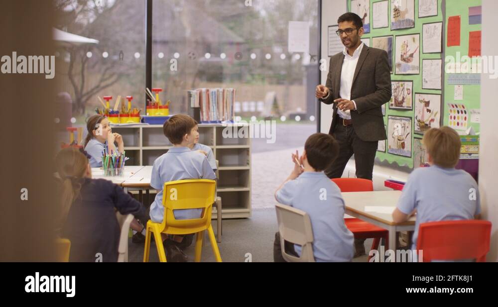 4k, Elementary children and their teacher in a lesson at school. Slow ...
