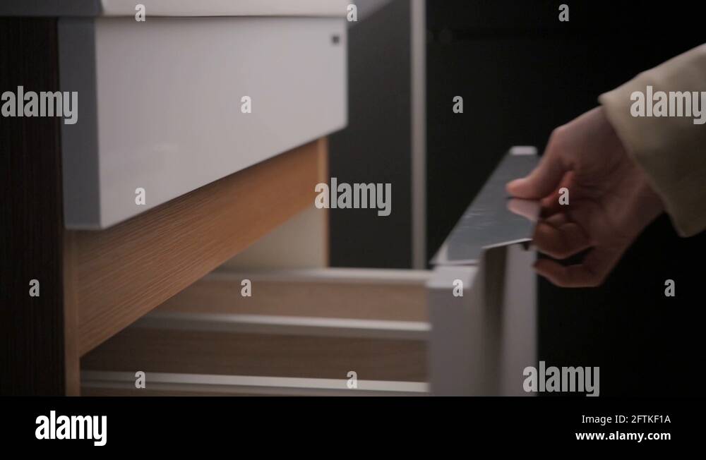 kitchen cabinet, woman close cupboard door, closer in bathroom Stock ...