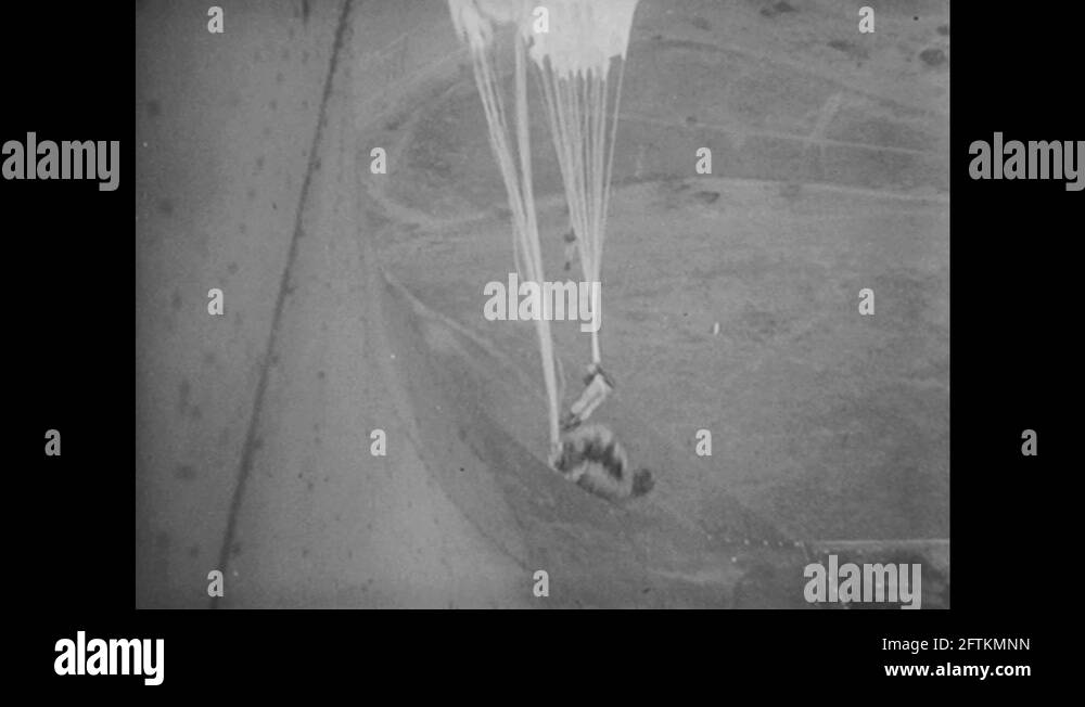 1940s: Aerial view, paratroopers jump from plane / Paratrooper falling ...