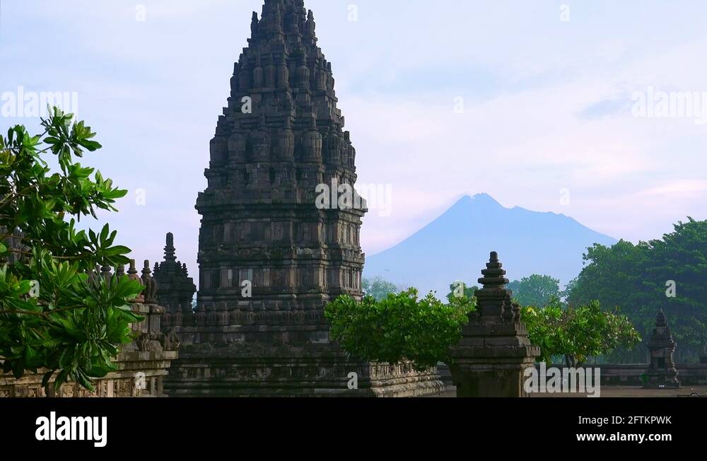 Prambanan Hindu temple complex against active volcano Mount Merapi ...