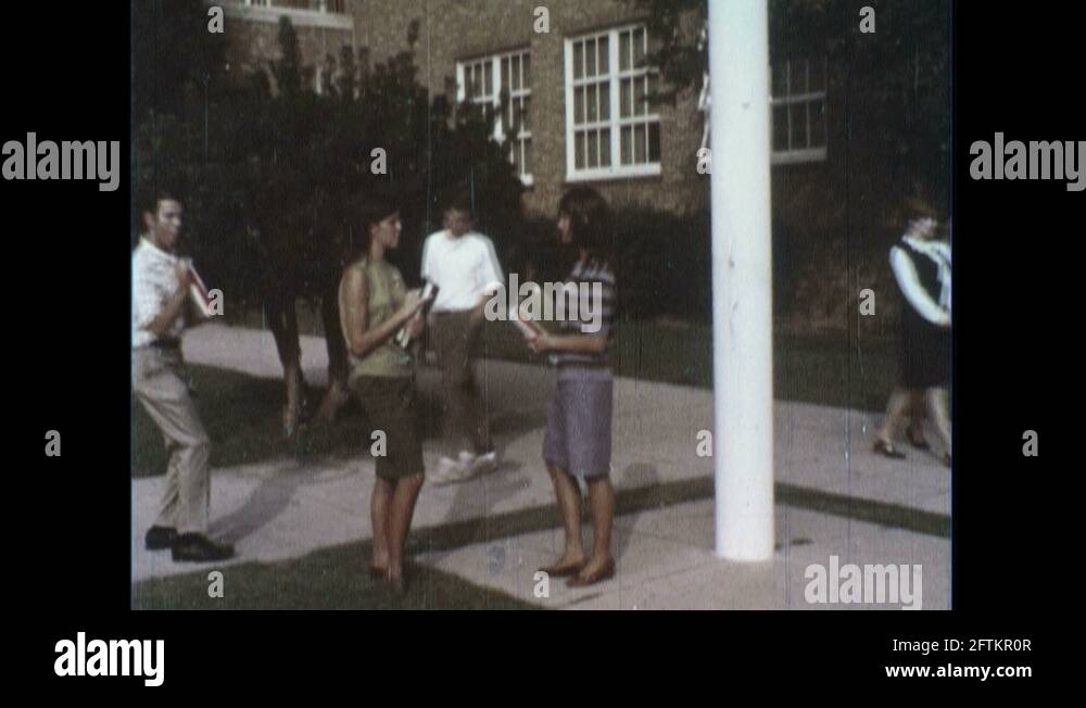 College students standing around and conversing throughout the campus ...