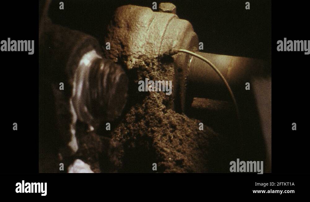 1970s : Workman's Cleaning Utensil Becomes Entangled in Mine Conveyor ...