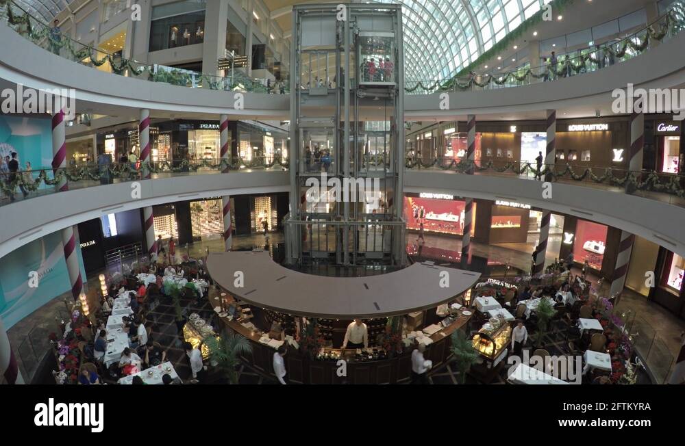 Glass Elevators over an Atrium Restaurant at the Mall inside Marina Bay ...