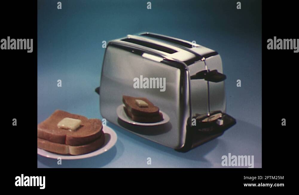1960s: Toaster with toast, hand puts bread in toaster / Hand adjusts ...