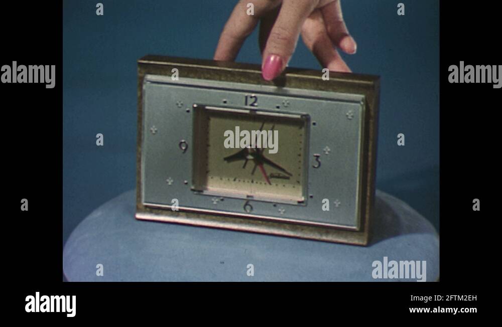 1960s: Hand pivots clock on pedestal / Display of different colored ...