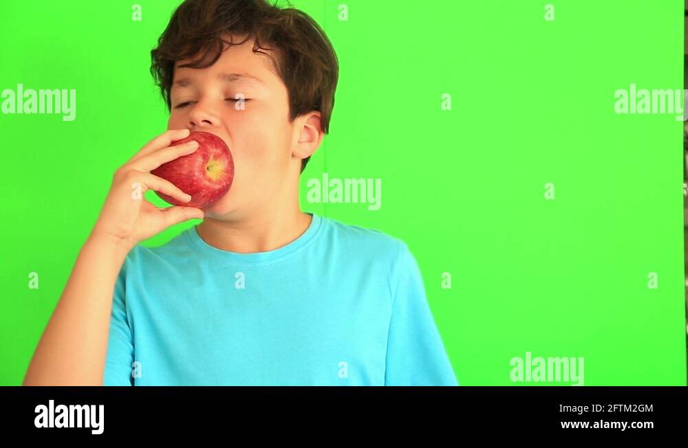 Child eating apple on chroma key background Stock Video Footage - Alamy