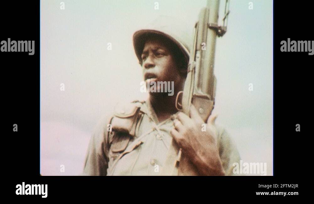 1960s: Close up of soldier / Aerial view, helicopters land, soldiers ...
