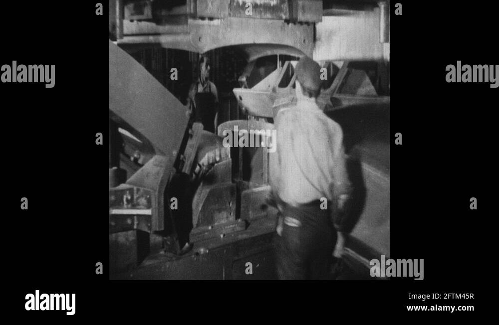 1930s-1940s : Two factory workers place the steel exterior of a car ...