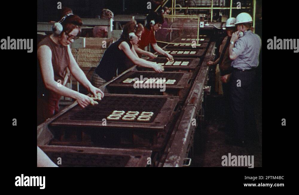 1970s: Workers place parts on assembly line / Molten metal pouring from ...