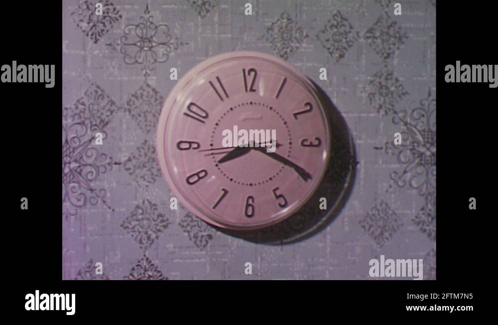 1960s: Montage of different wall clocks / Hands display cord in back of ...