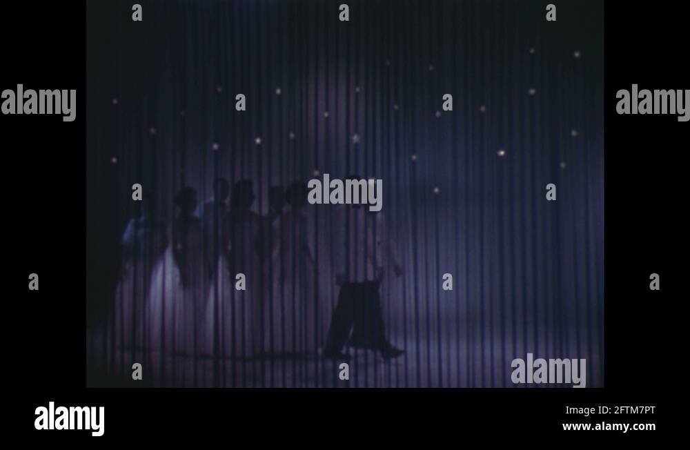 1960s: Group of singers walk onto stage from behind screen, sings into ...