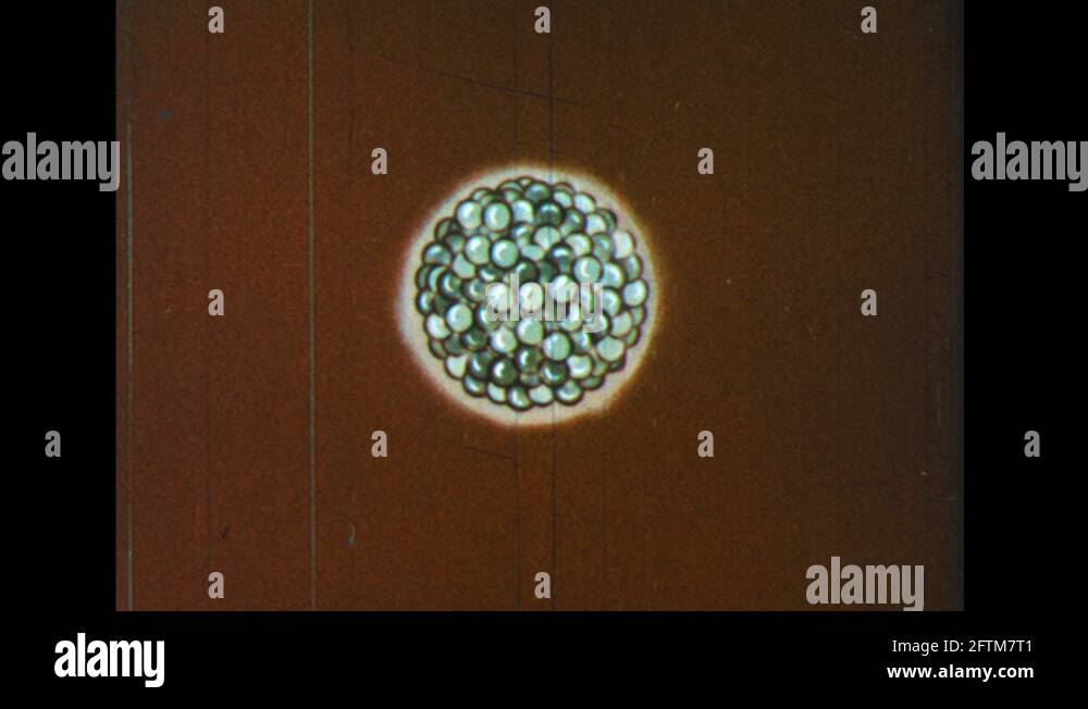 Animated. An atom's nucleus. A binding force glows around the nucleus ...
