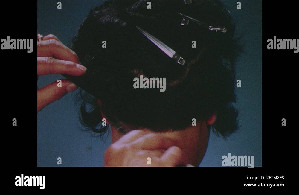 1960s: Back of woman's head, hands cut hair Stock Video Footage - Alamy