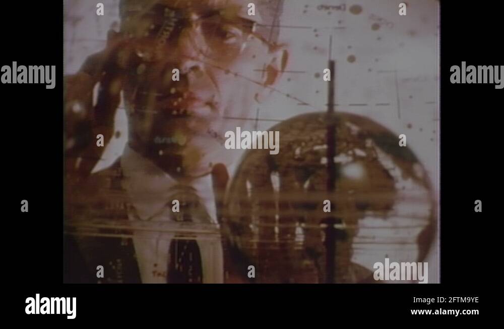 1970s: Man consults map of solar system / Scientist in lab / Scientist ...